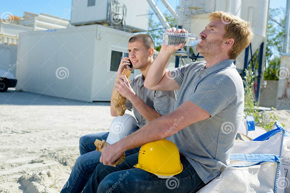 Two Men Eating Their Lunch on Construction Site Stock Photo - Image of ...