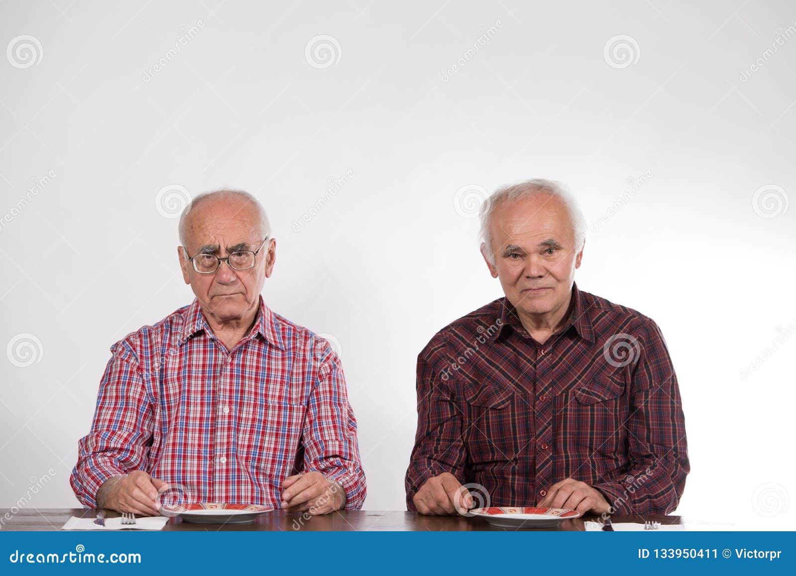 Two men with empty plates stock image. Image of time - 133950411