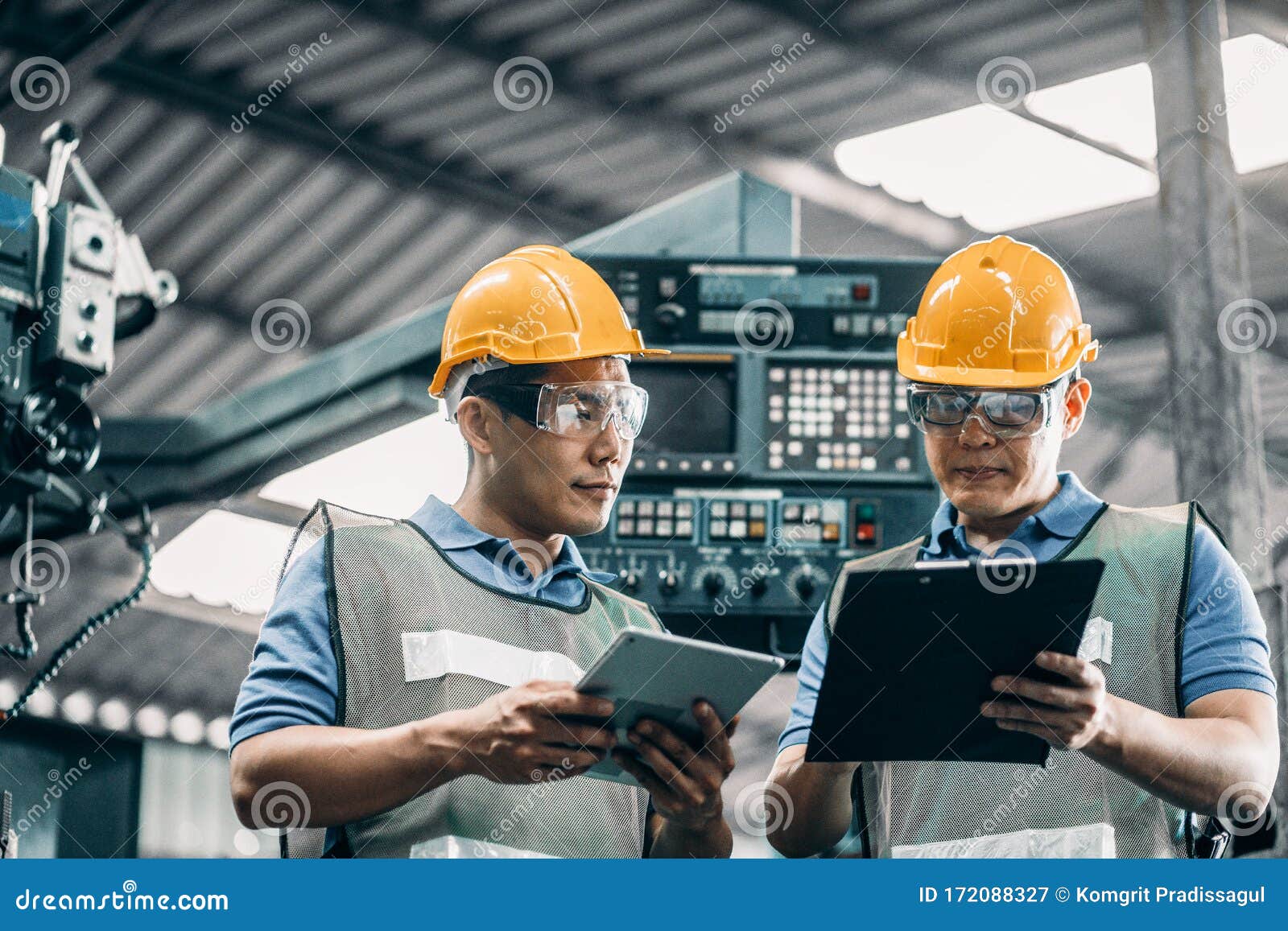 Mechanic and Staff Engineer Talking Nearby a Machine in a Big Factory ...