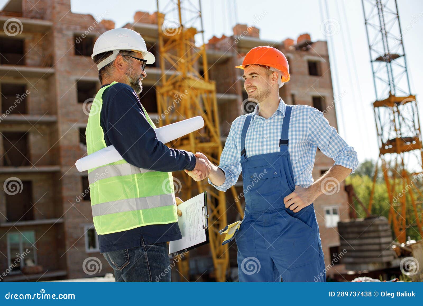 Two Men Engineers at a Construction Site are Looking at the Drawings ...
