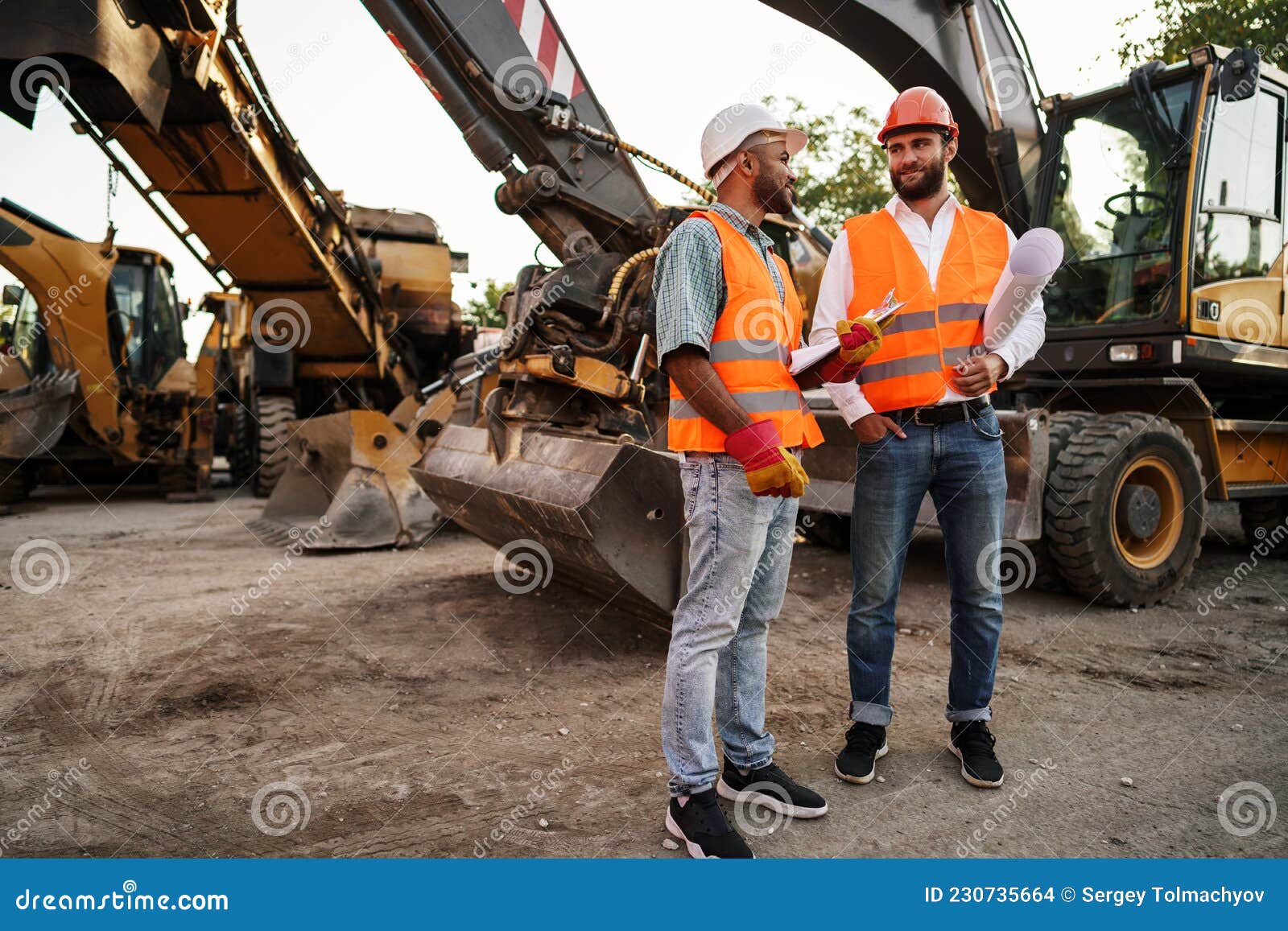 Two Men Engineers Discussing Their Work Standing Against Construction ...