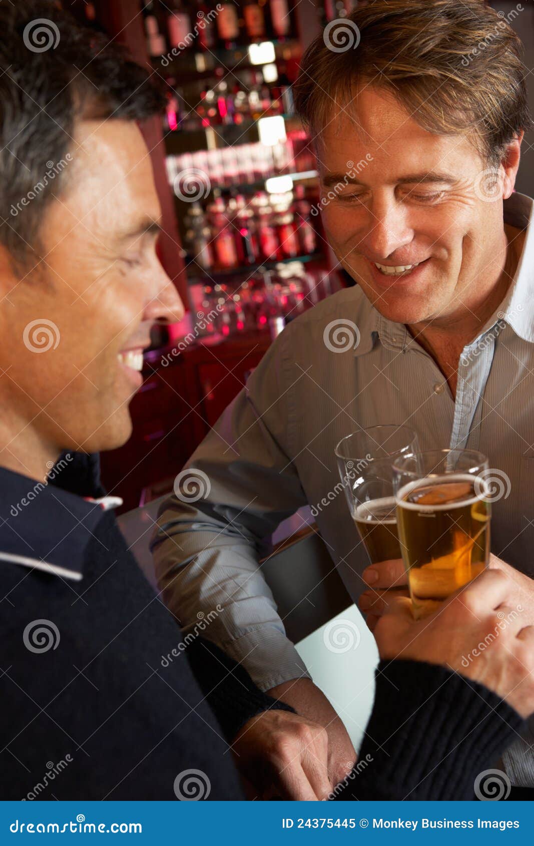 Two Men Enjoying Drink Together in Bar Stock Image - Image of caucasian ...
