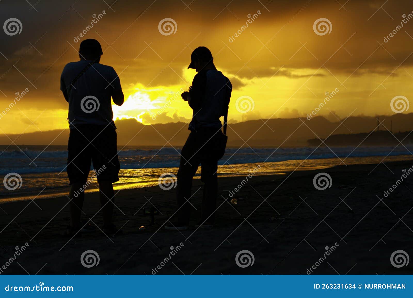 Two Men Enjoying the Sunset on the Beach Stock Photo - Image of beach ...