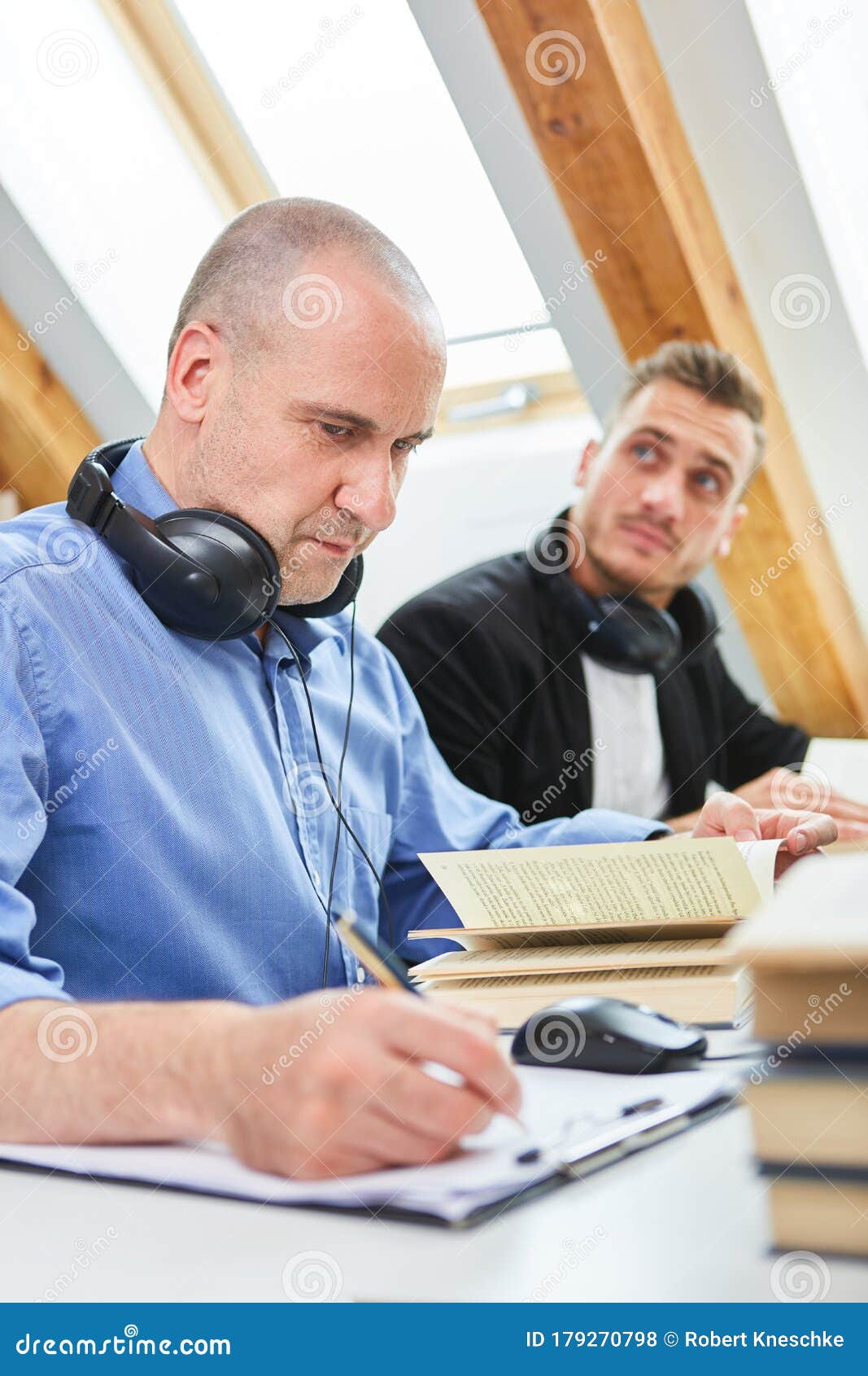 Two men in an exam or exam stock photo. Image of college - 179270798