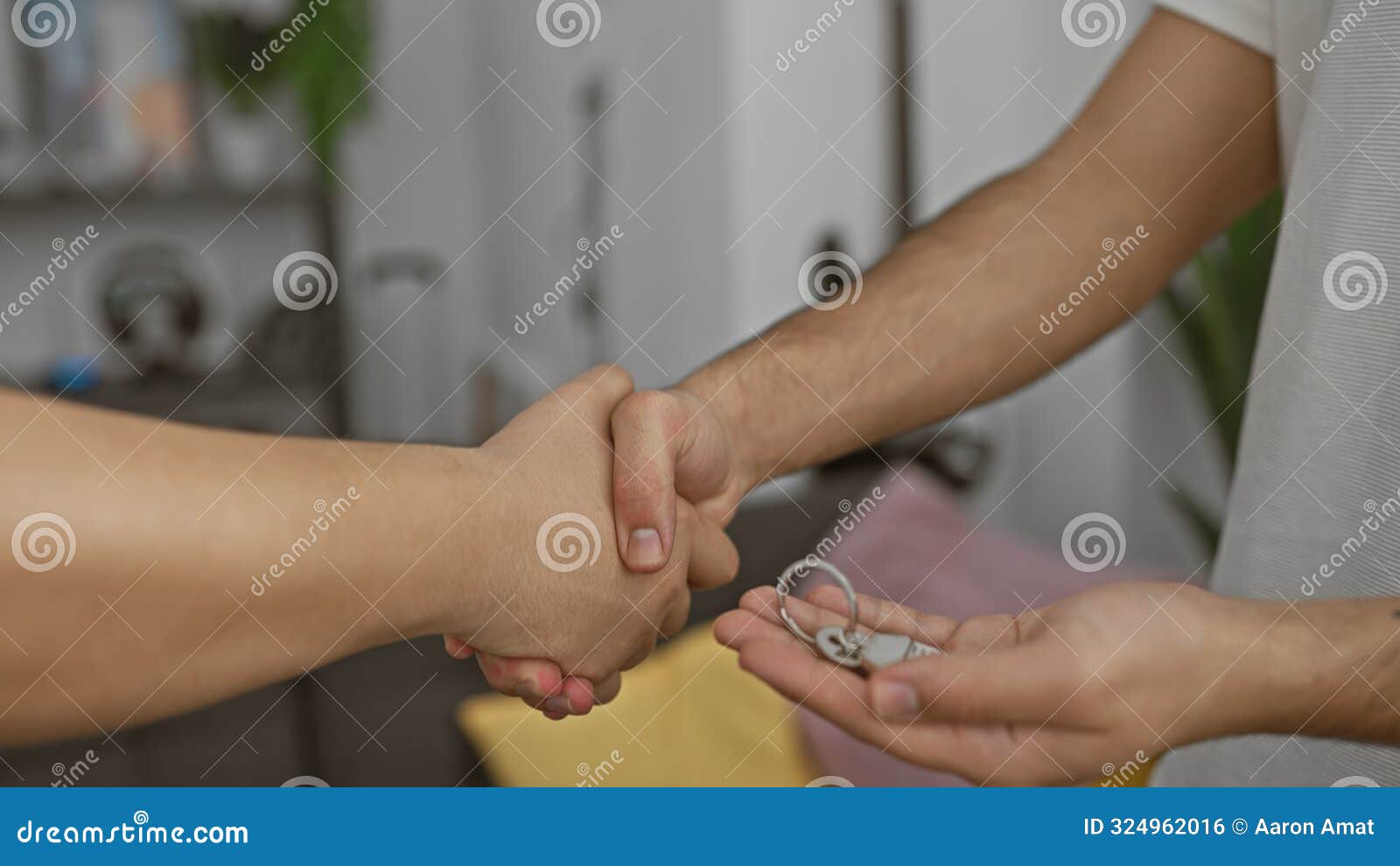 Two Men Exchanging Keys in a Casual Indoor Environment, Symbolizing ...