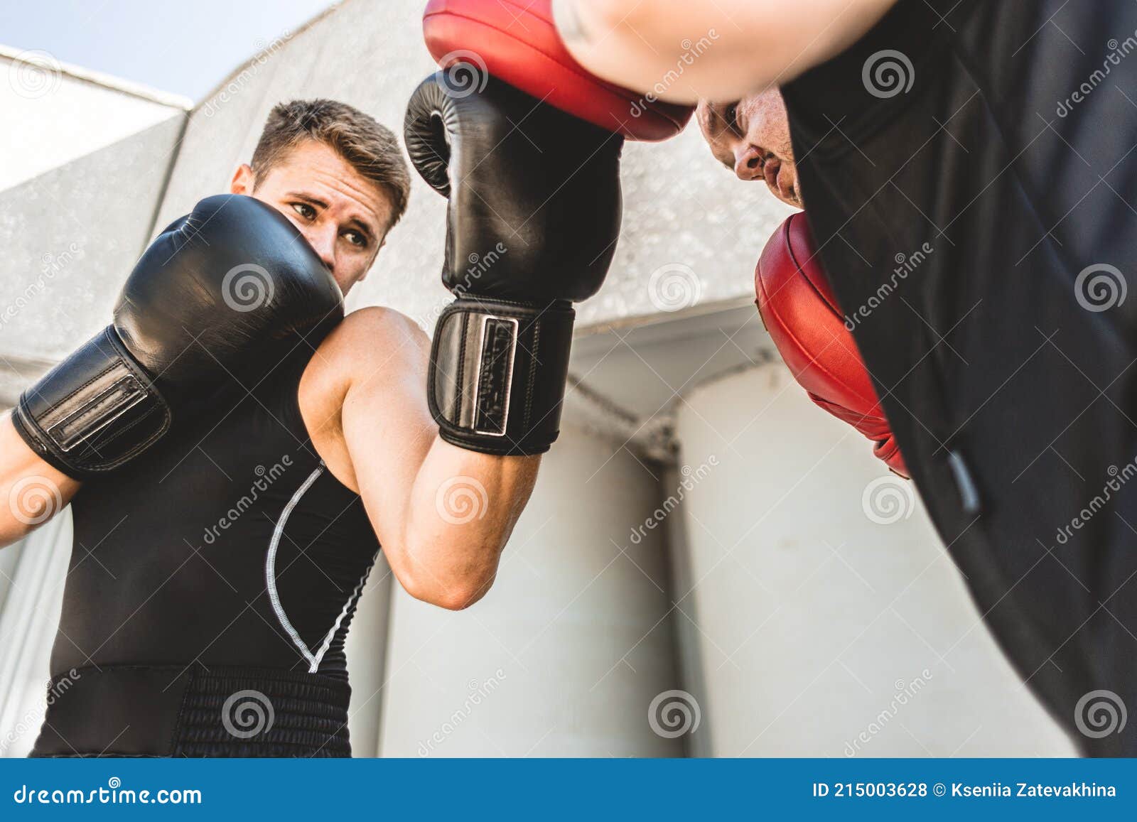 Two Men Exercising and Fighting in Outside. Boxer in Gloves is Training ...