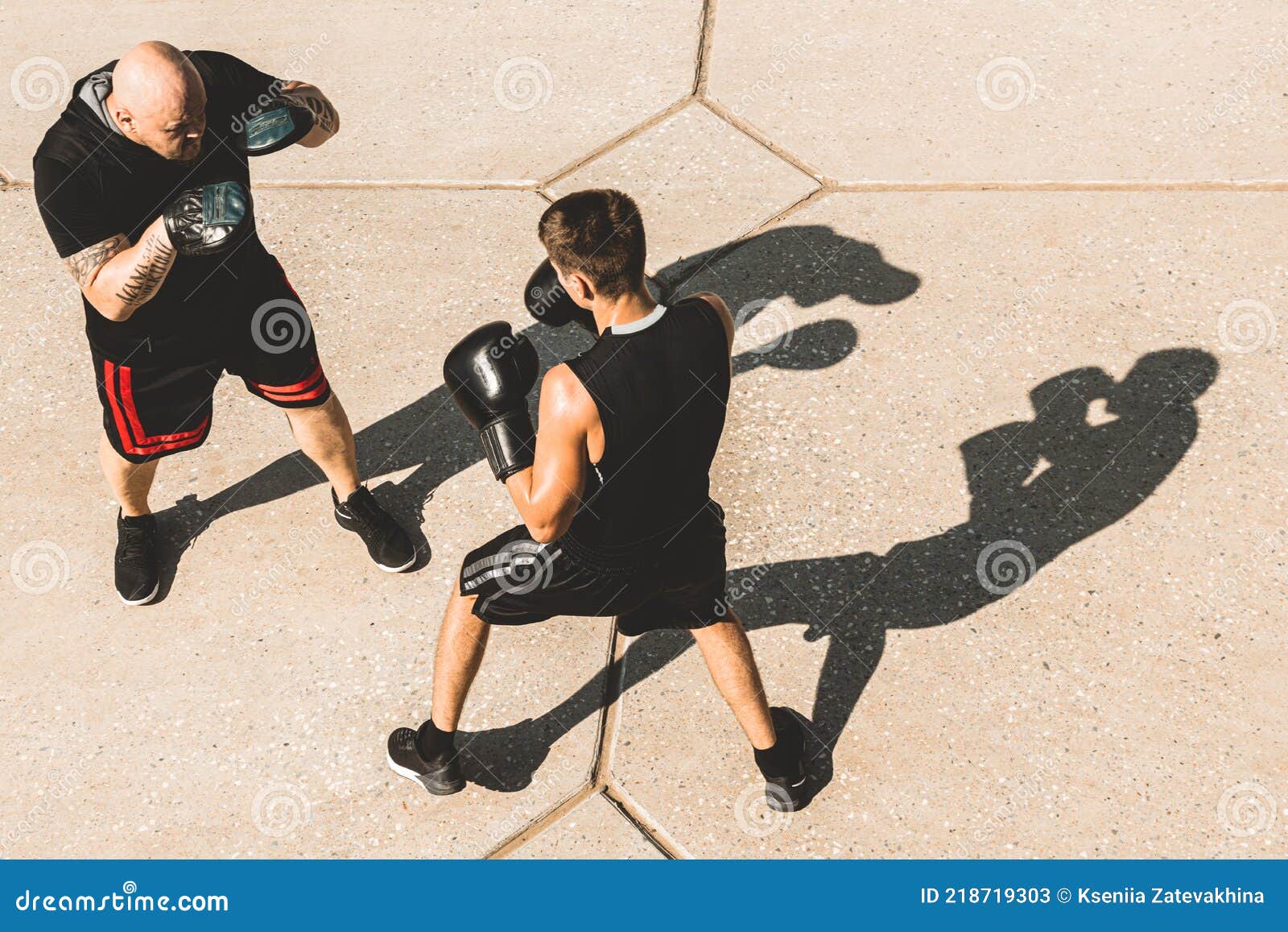 Two Men Exercising and Fighting in Outside. Boxer in Gloves is Training ...