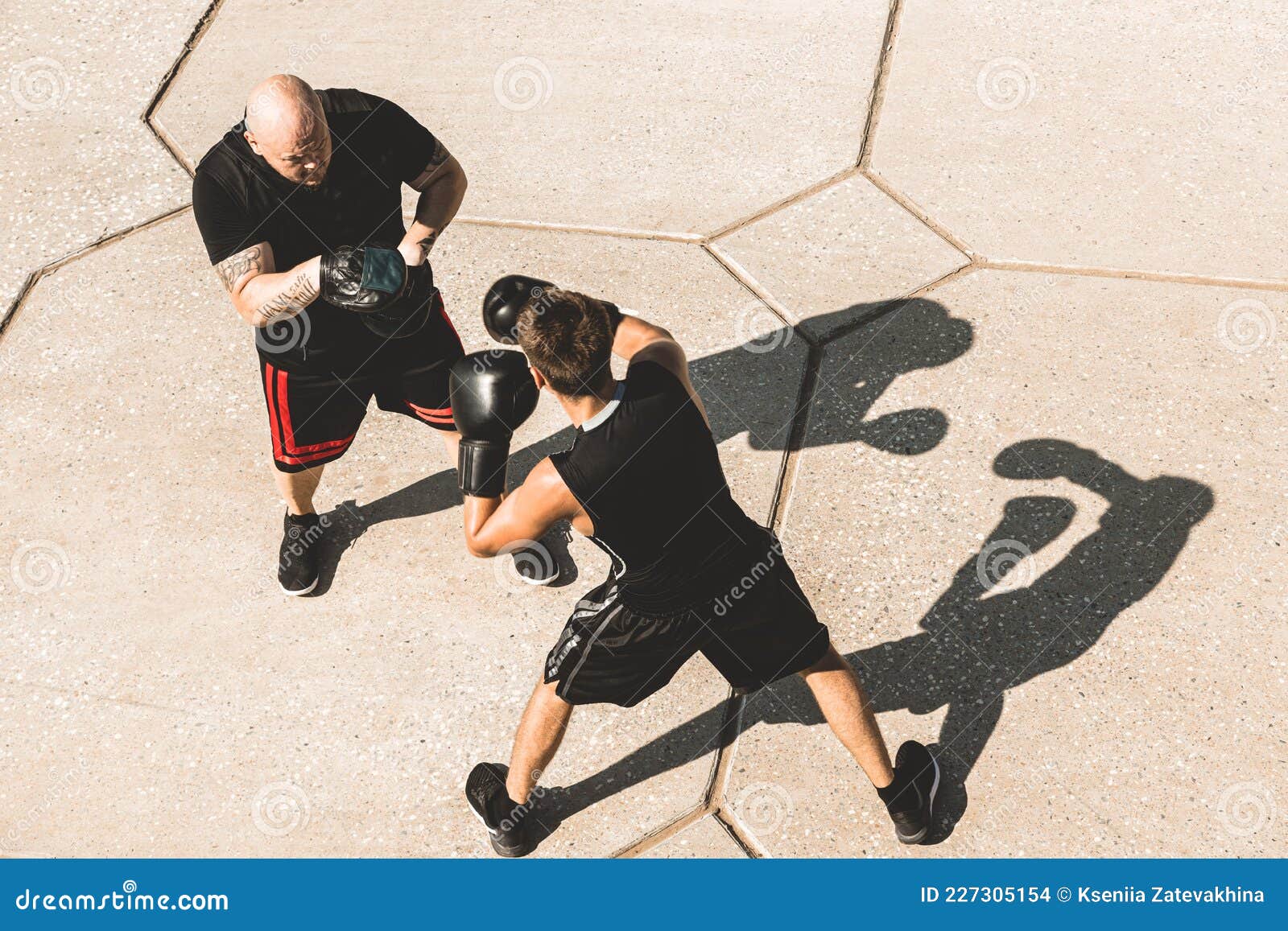 Two Men Exercising and Fighting in Outside. Boxer in Gloves is Training ...
