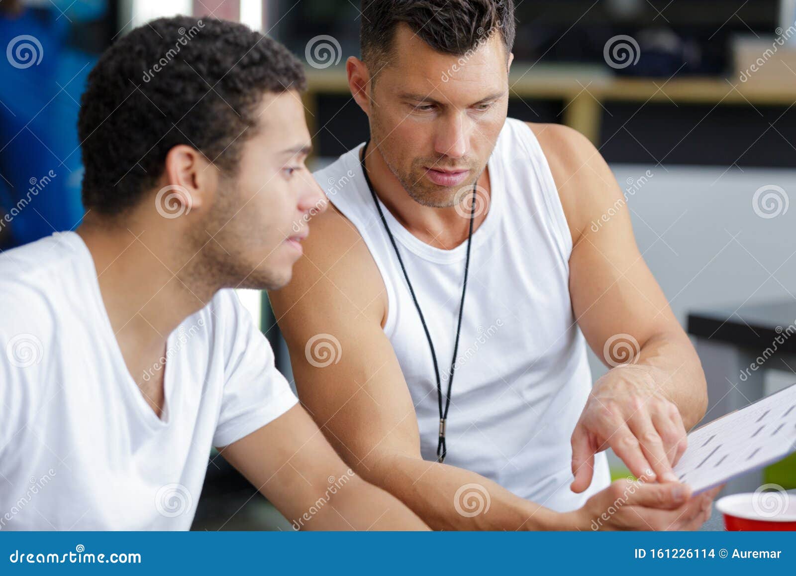 Two men exercising in gym stock photo. Image of equipment - 161226114