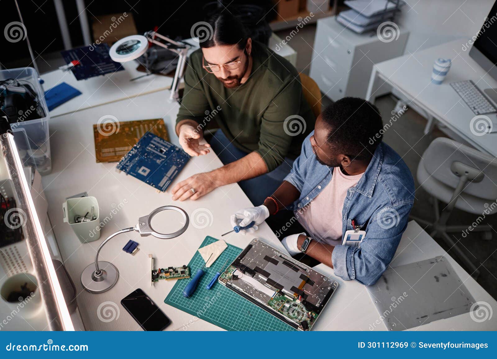 Two men fixing electronics stock image. Image of build - 301112969