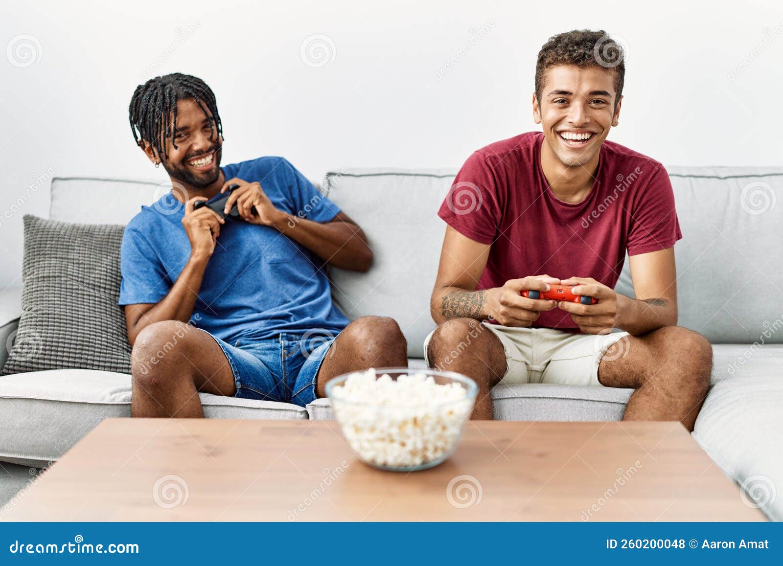 Two Men Friends Playing Video Game Sitting on Sofa at Home Stock Photo ...