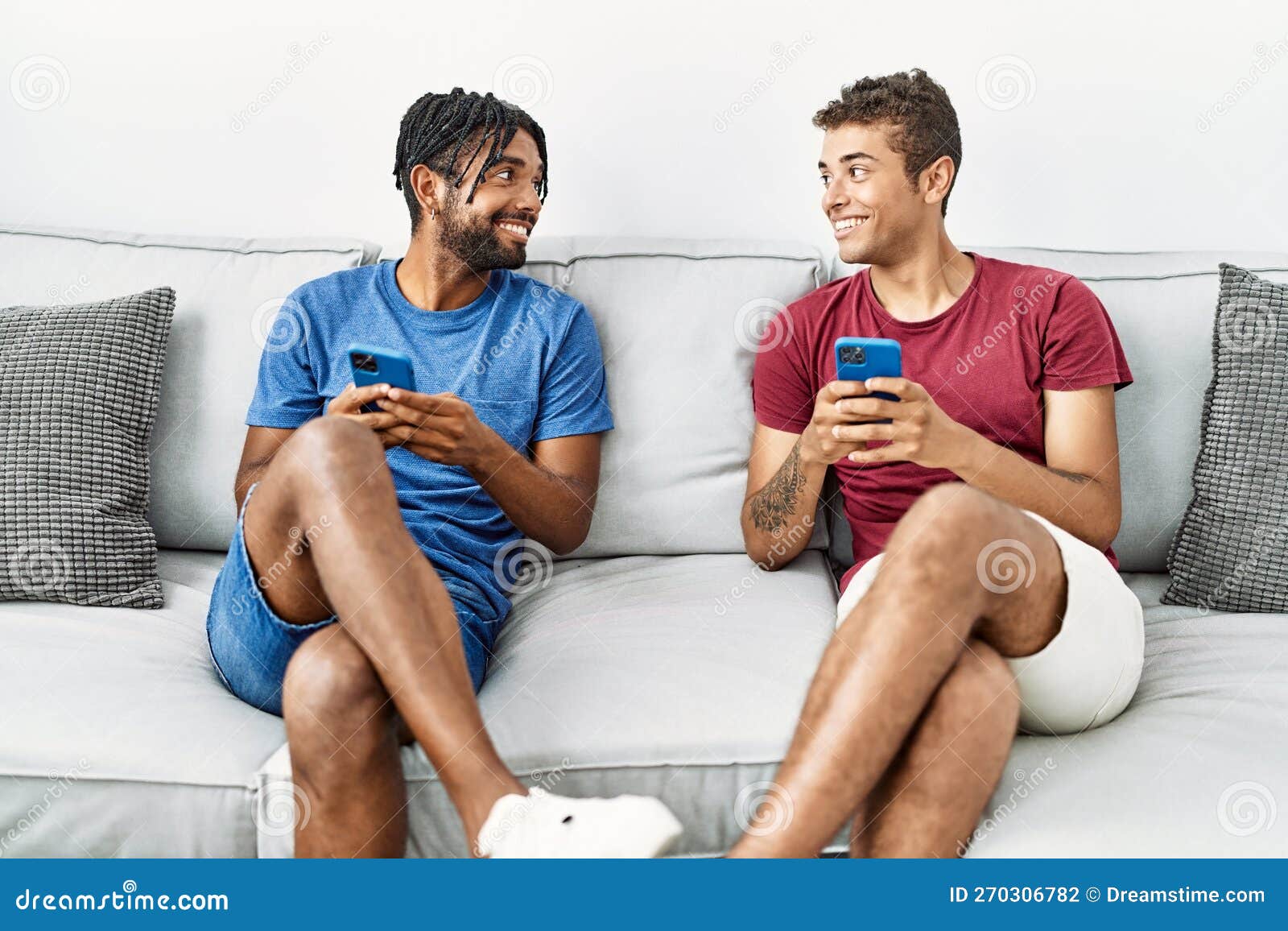 Two Men Friends Using Smartphone Sitting on Sofa at Home Stock Photo ...