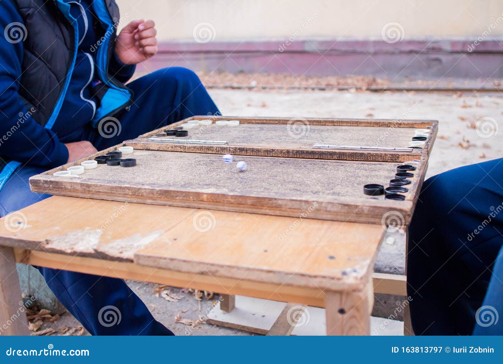 Two Men Gamble in the Street Playing Backgammon in the Fall Stock Image ...