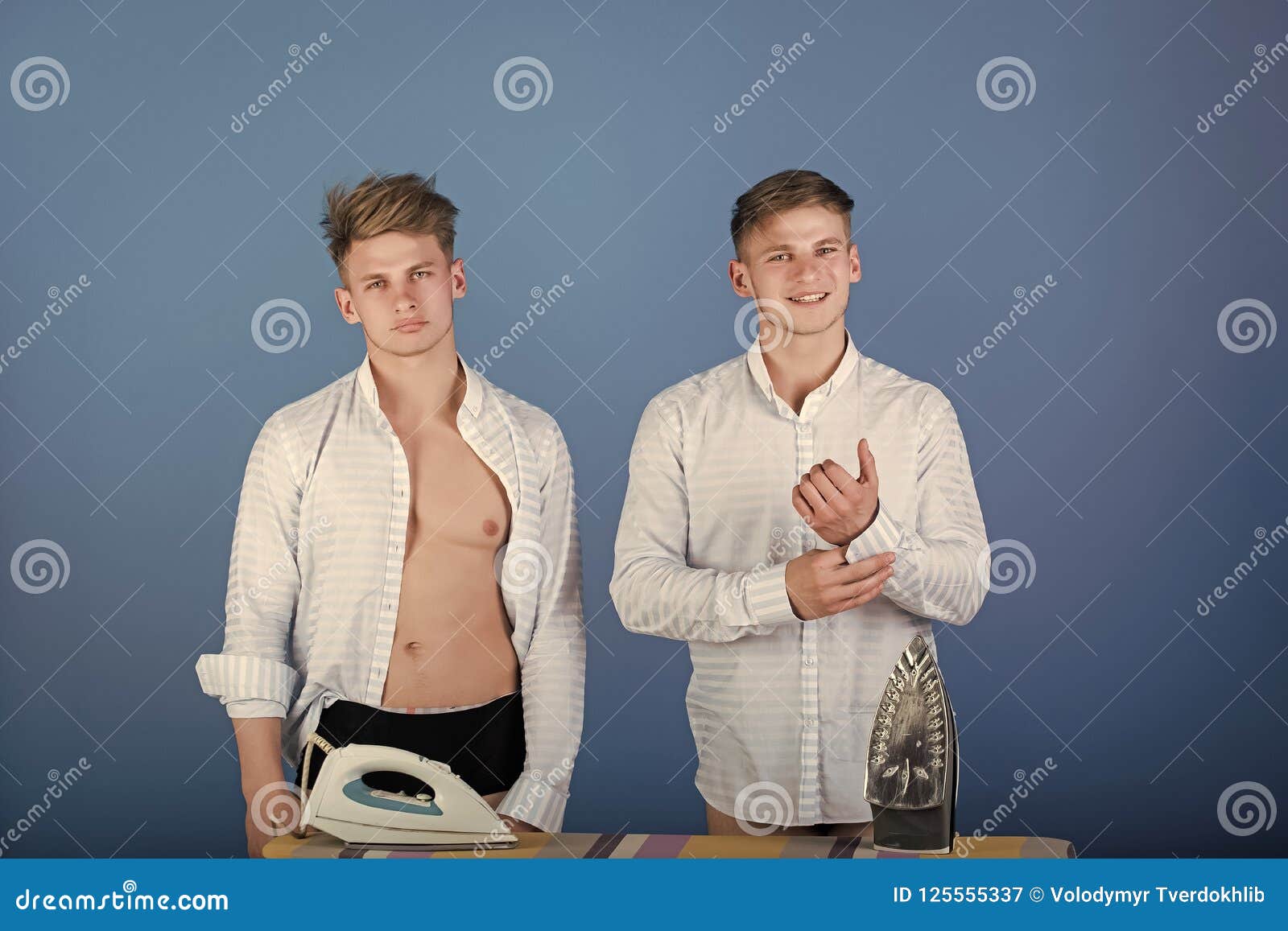 Two men getting dressed stock image. Image of muscle - 125555337