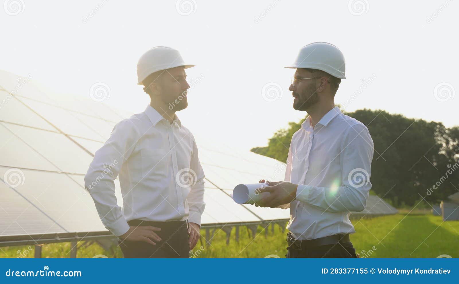 Two Men in Hard Helmets Discussing Project at Solar Farm. Male ...