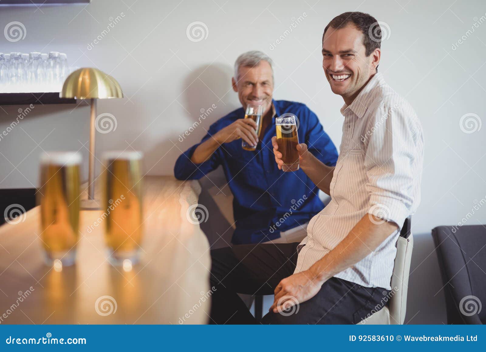 Two Men Having Beer Together Stock Photo - Image of business, indoors ...