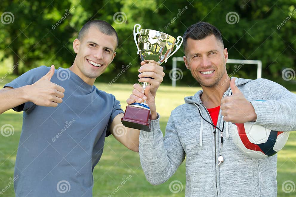 Two men holding trophy stock image. Image of metal, confident - 281820133