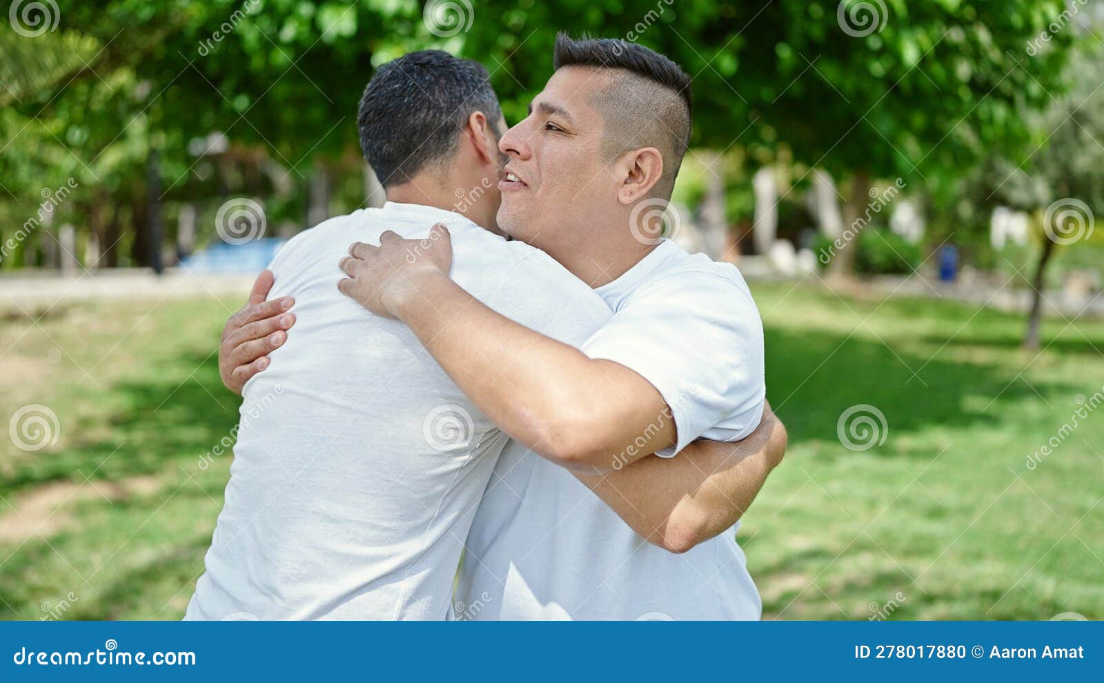 Two Men Hugging Each Other with Relaxed Expression at Park Stock Photo ...