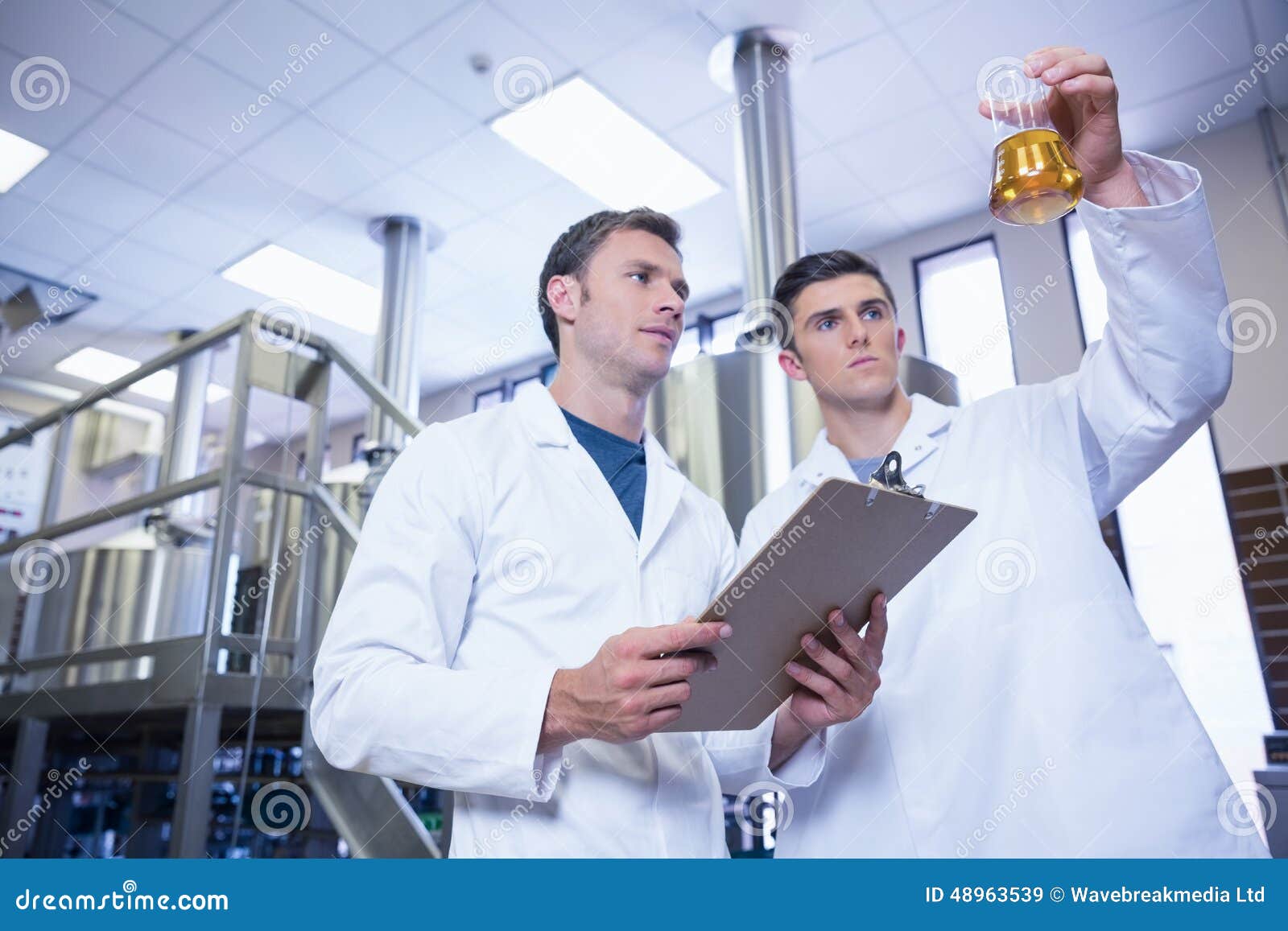 Two Men in Lab Coat Looking at the Beaker with Beer Stock Image - Image ...