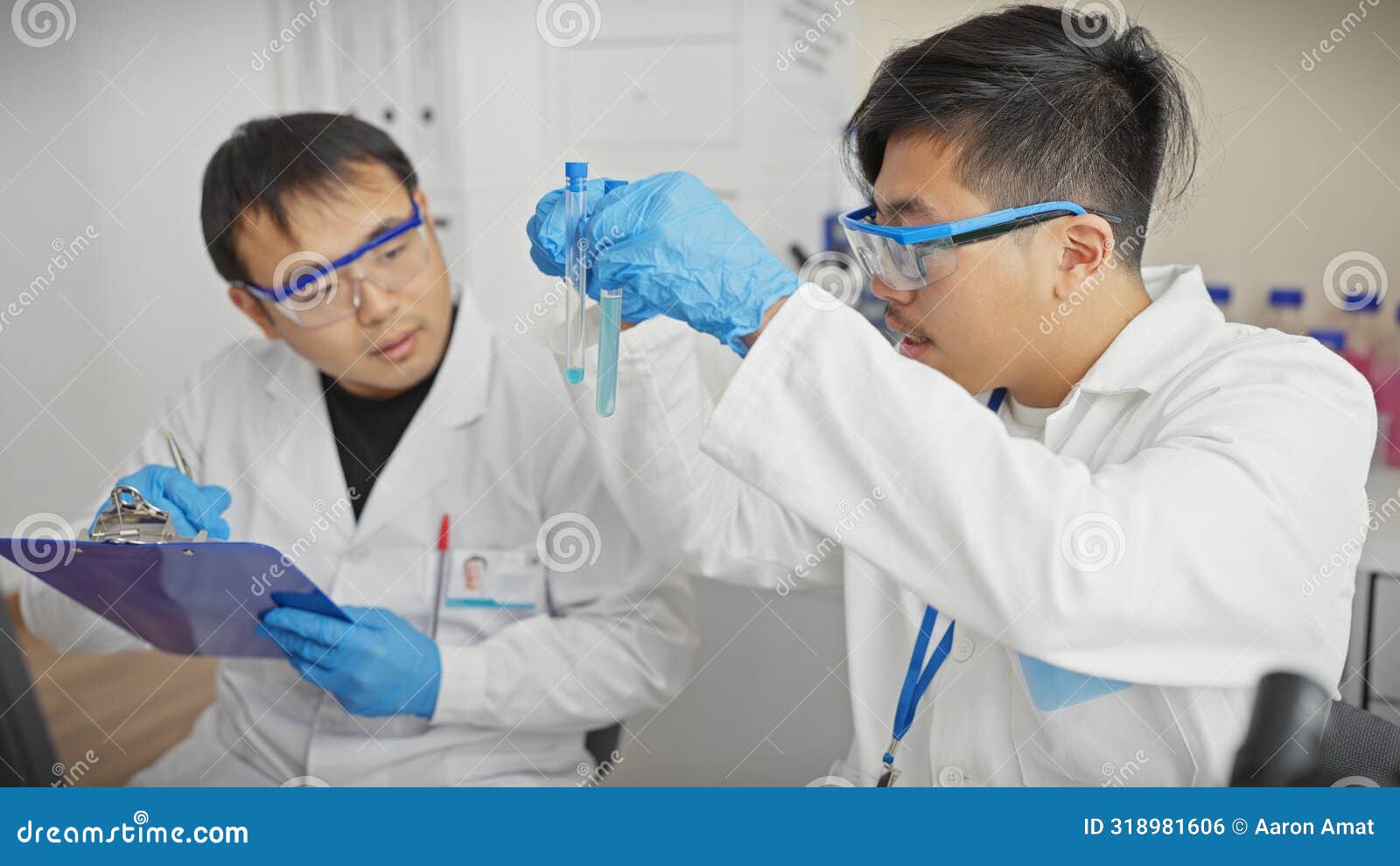 Two Men in Lab Coats Analyze Samples in a Science Laboratory, Embodying ...