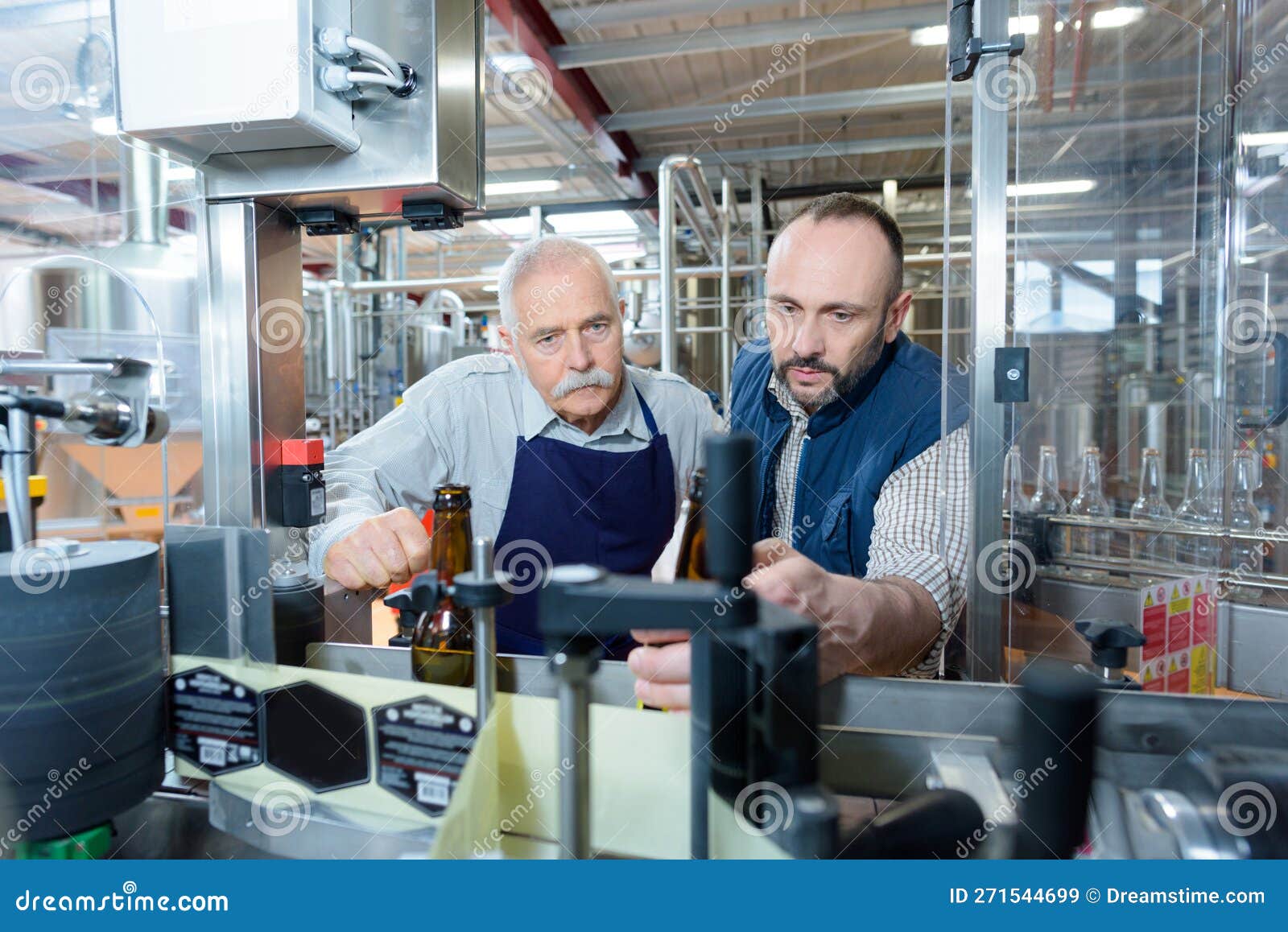Two Men by Labelling Machine in Bottling Plant Stock Image - Image of ...