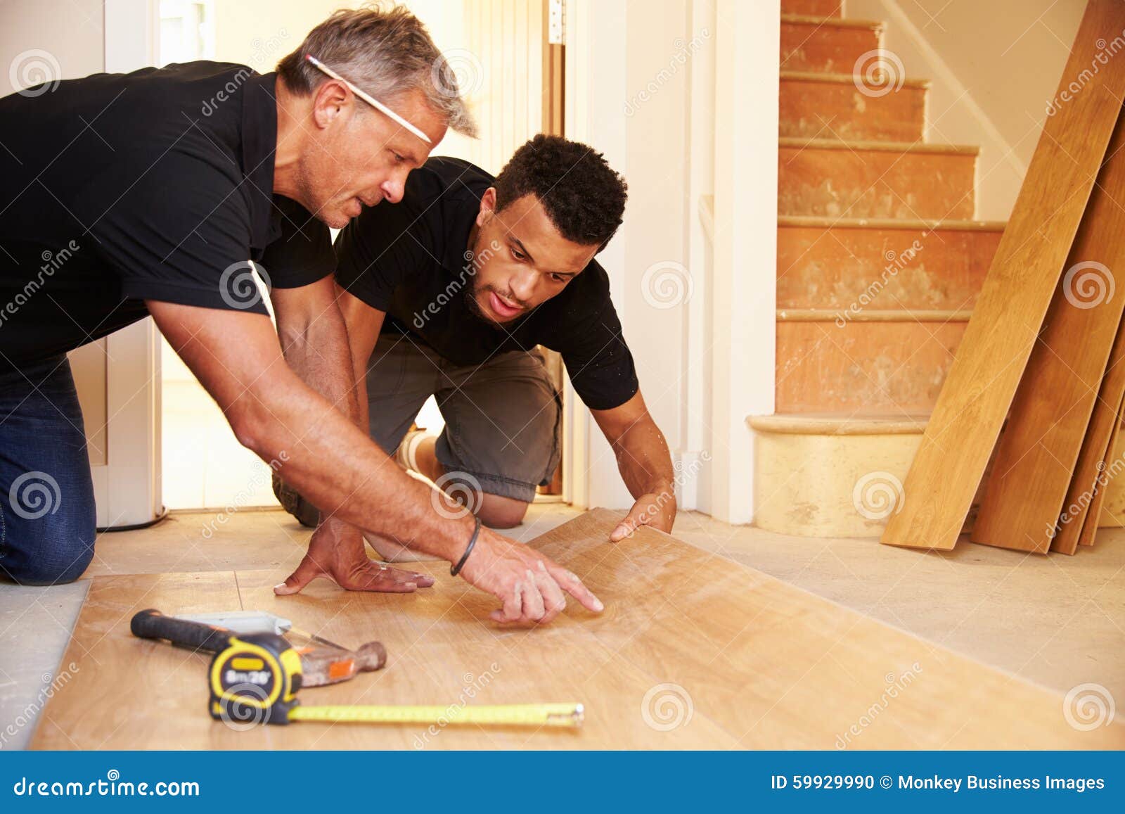 Two Men Laying Wood Panel Flooring in a House Stock Photo - Image of ...