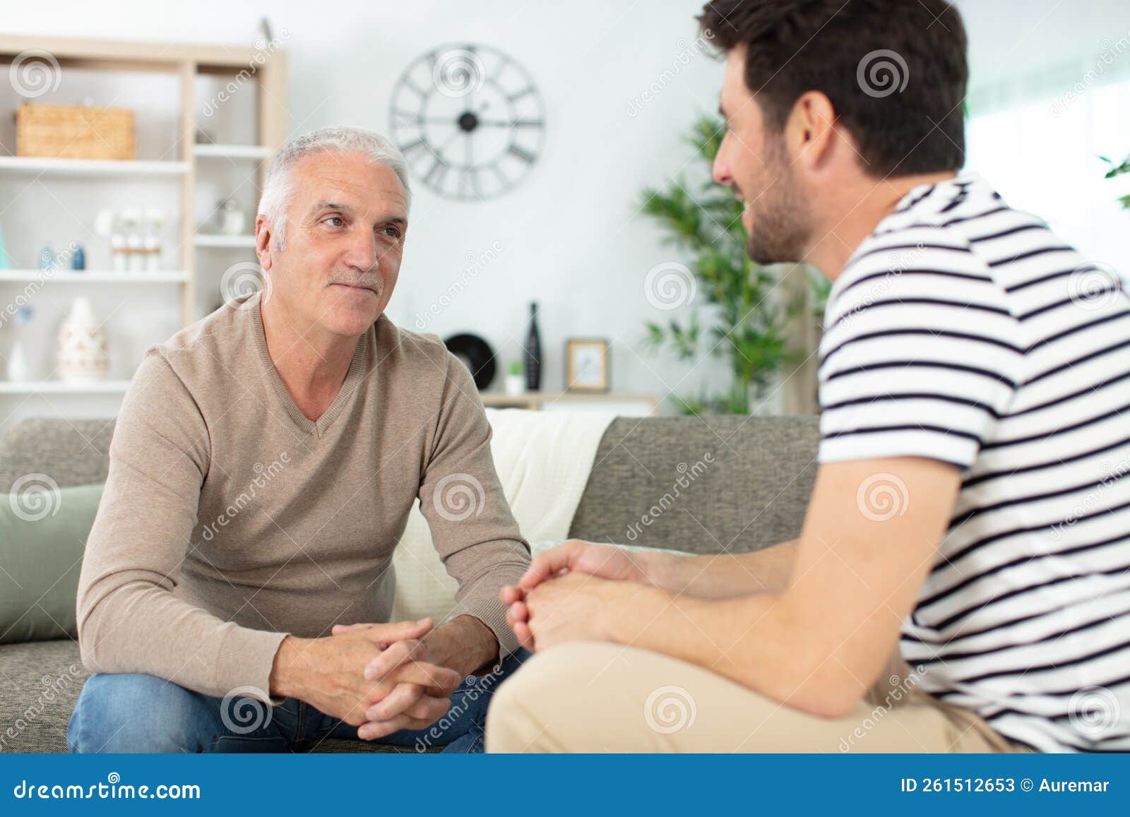 Two Men in Living Room Talking and Smiling Stock Image - Image of ...