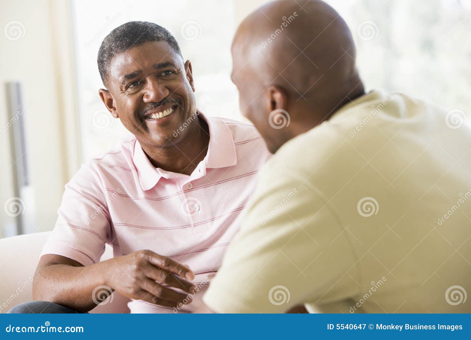 Two Men in Living Room Talking and Smiling Stock Image - Image of male ...