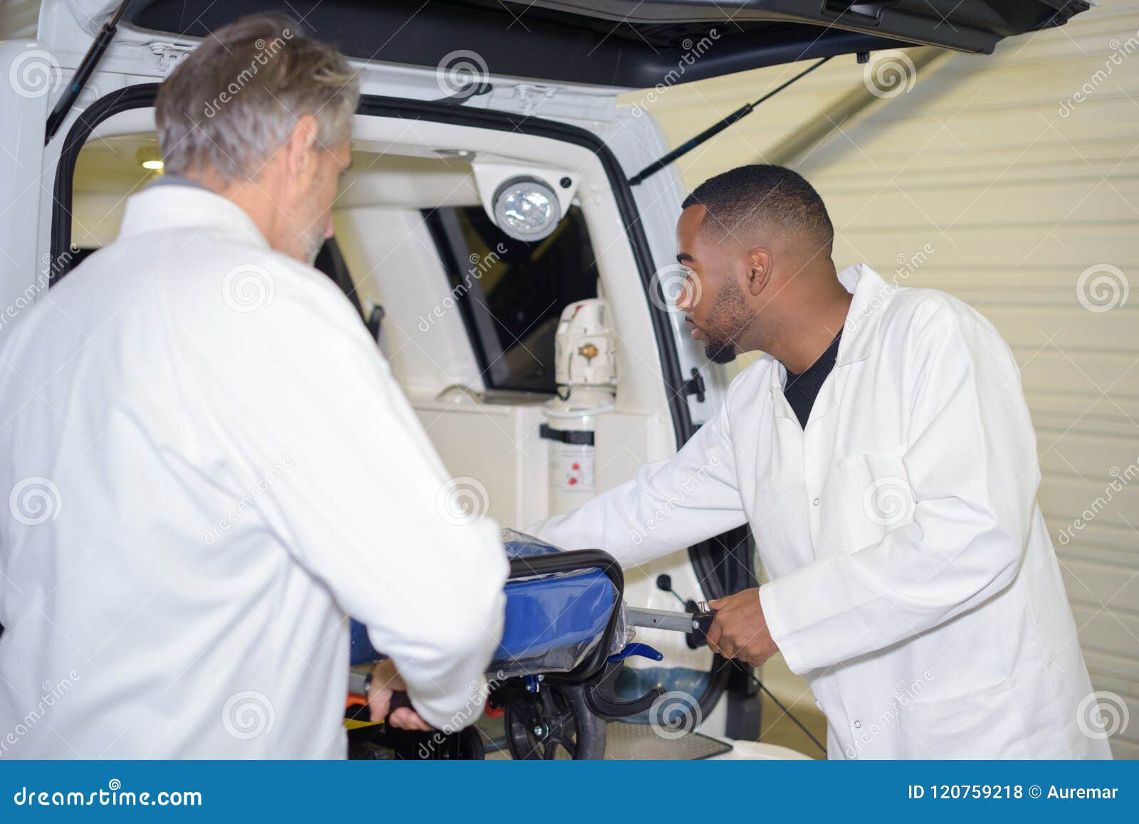 Two Men Loading Stretcher into Ambulance Stock Photo - Image of vehicle ...