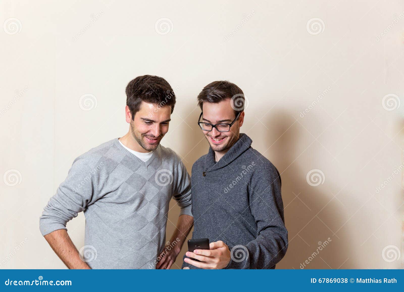 Two Men are Looking on a Cell Phone Stock Photo - Image of standing ...