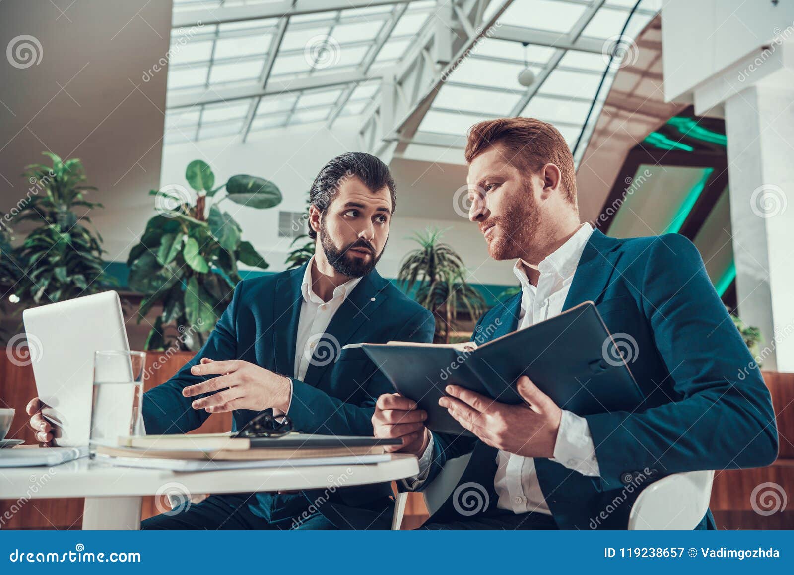 Two Men Looking at Laptop Screen in Office. Stock Image - Image of ...