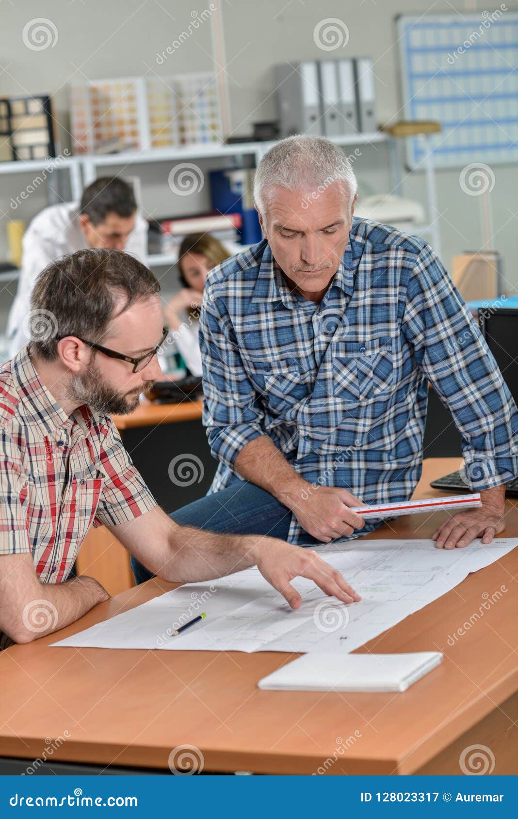 Two Men Looking Paperwork One Sat Table Stock Photos - Free & Royalty ...