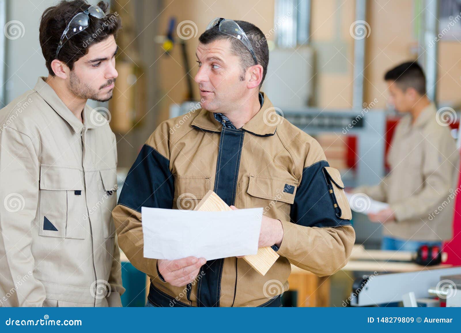 Two Men Measuring Detail and Assembling Product Stock Image - Image of ...