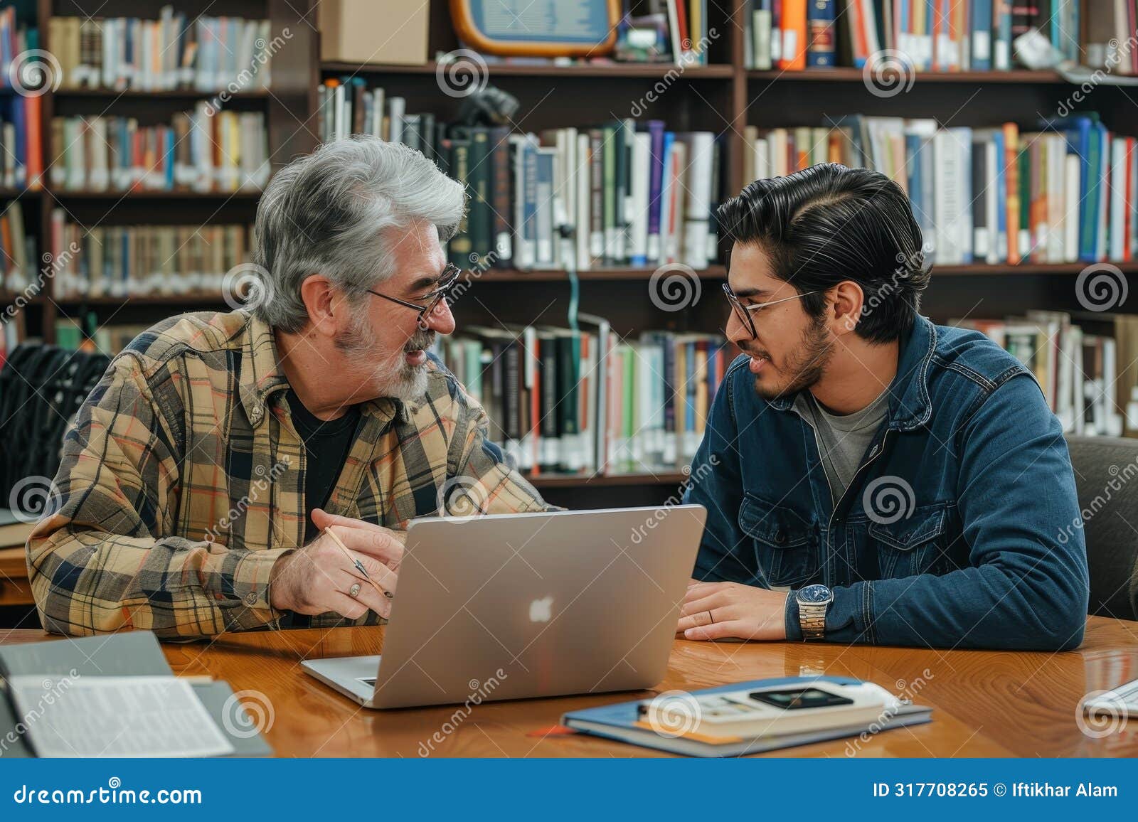 Two Men, a Mentor and Mentee, Engaged in a Discussion while Seated at a ...