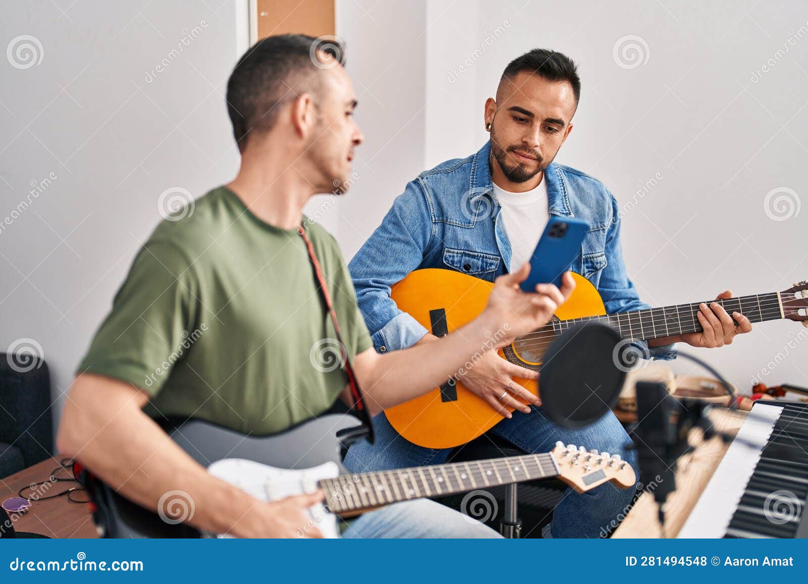 Two Men Musicians Playing Classical and Electrical Guitar Looking ...