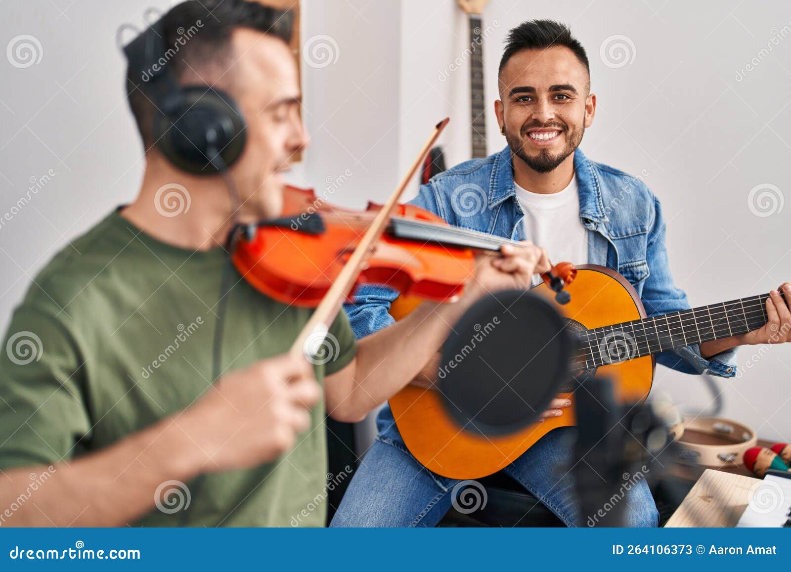 Two Men Musicians Playing Classical Guitar and Violin at Music Studio ...