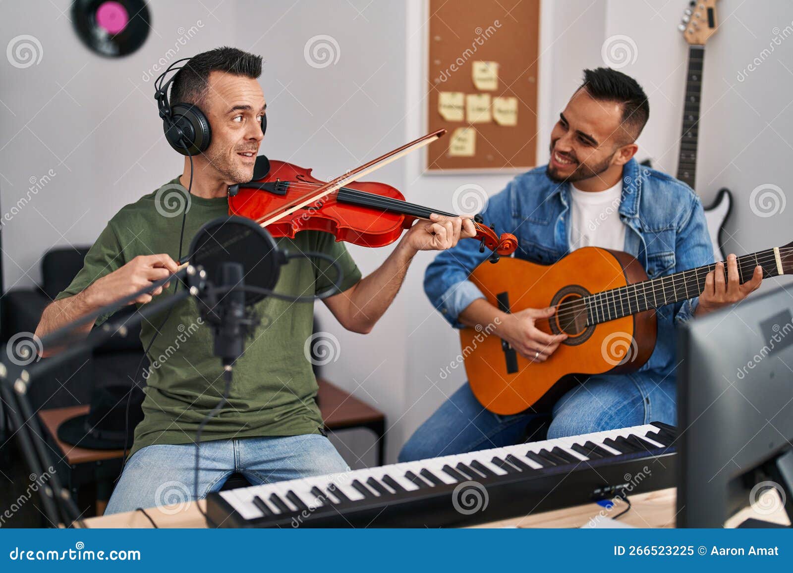 Two Men Musicians Playing Classical Guitar and Violin at Music Studio ...