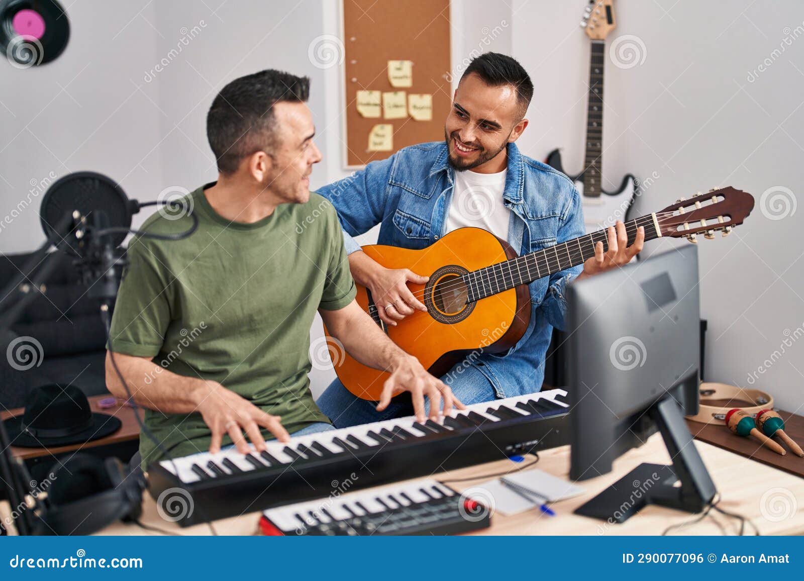 Two Men Musicians Playing Piano and Classical Guitar at Music Studio ...