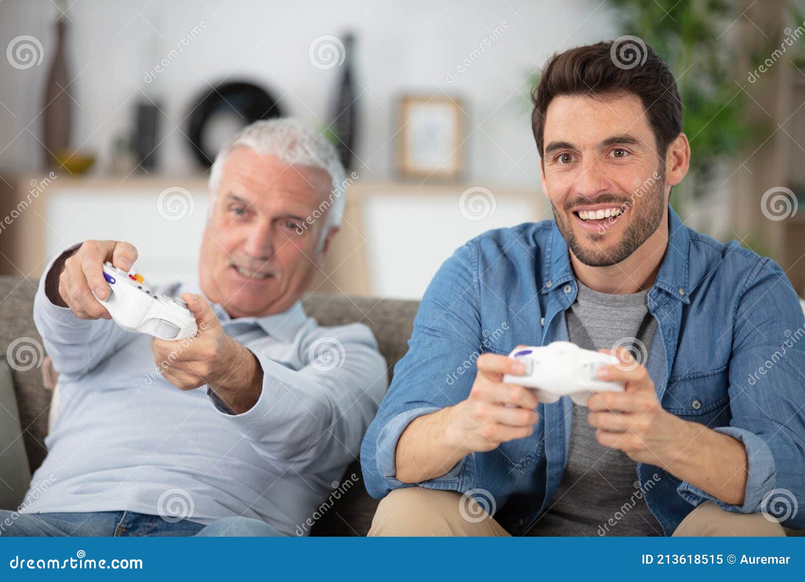 Two men play computer game stock image. Image of sofa - 213618515