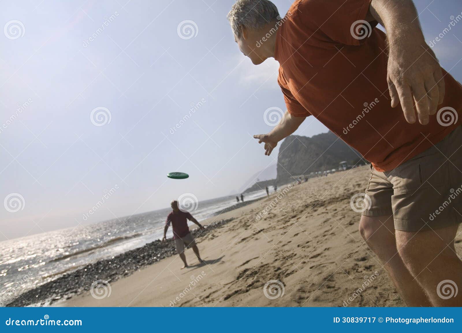 Two Men Playing with Flying Disc on Beach Stock Image - Image of blue ...