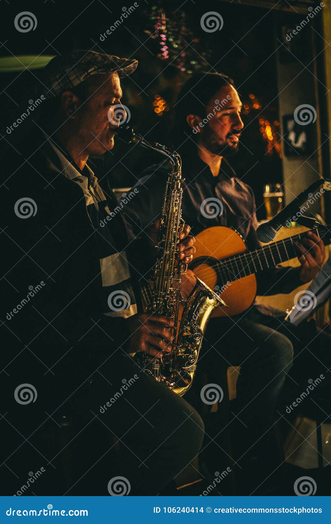 Two Men Playing Saxophone And Acoustic Guitar During Night Time Picture ...