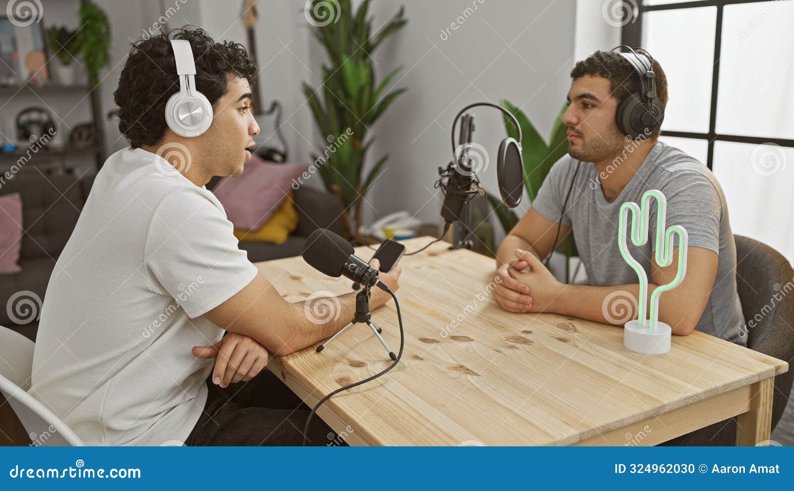 Two Men Podcasting in a Modern Home Studio with Headphones and ...