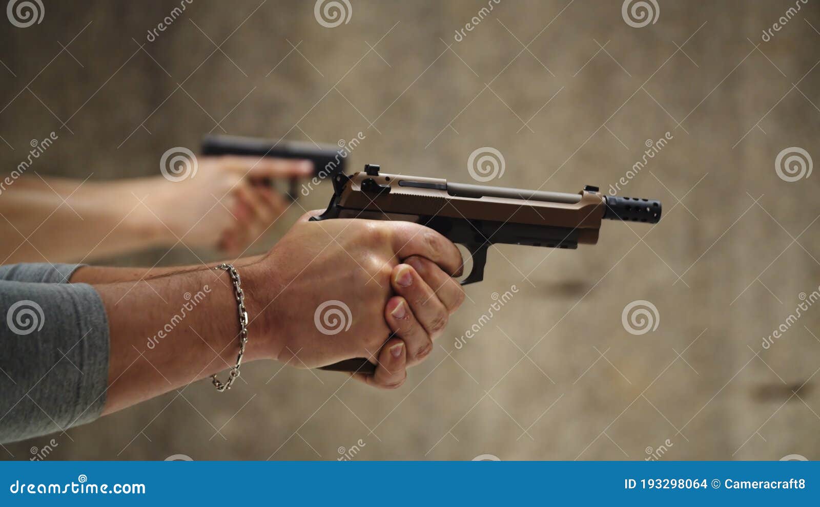 Two Men are Practicing Shooting with Hand Pistol at the Shooting Range ...