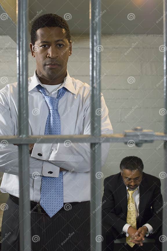 Two Men in Prison Cell stock photo. Image of businessmen - 29662868