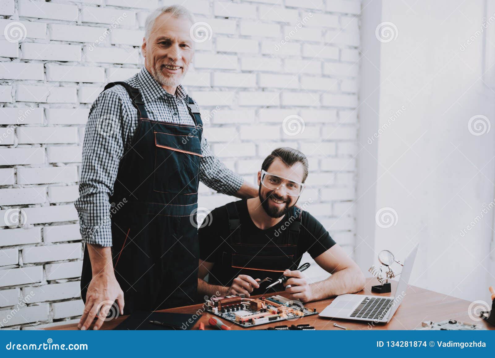 Two Men Repairing Hardware Equipment in Workshop. Stock Photo - Image ...