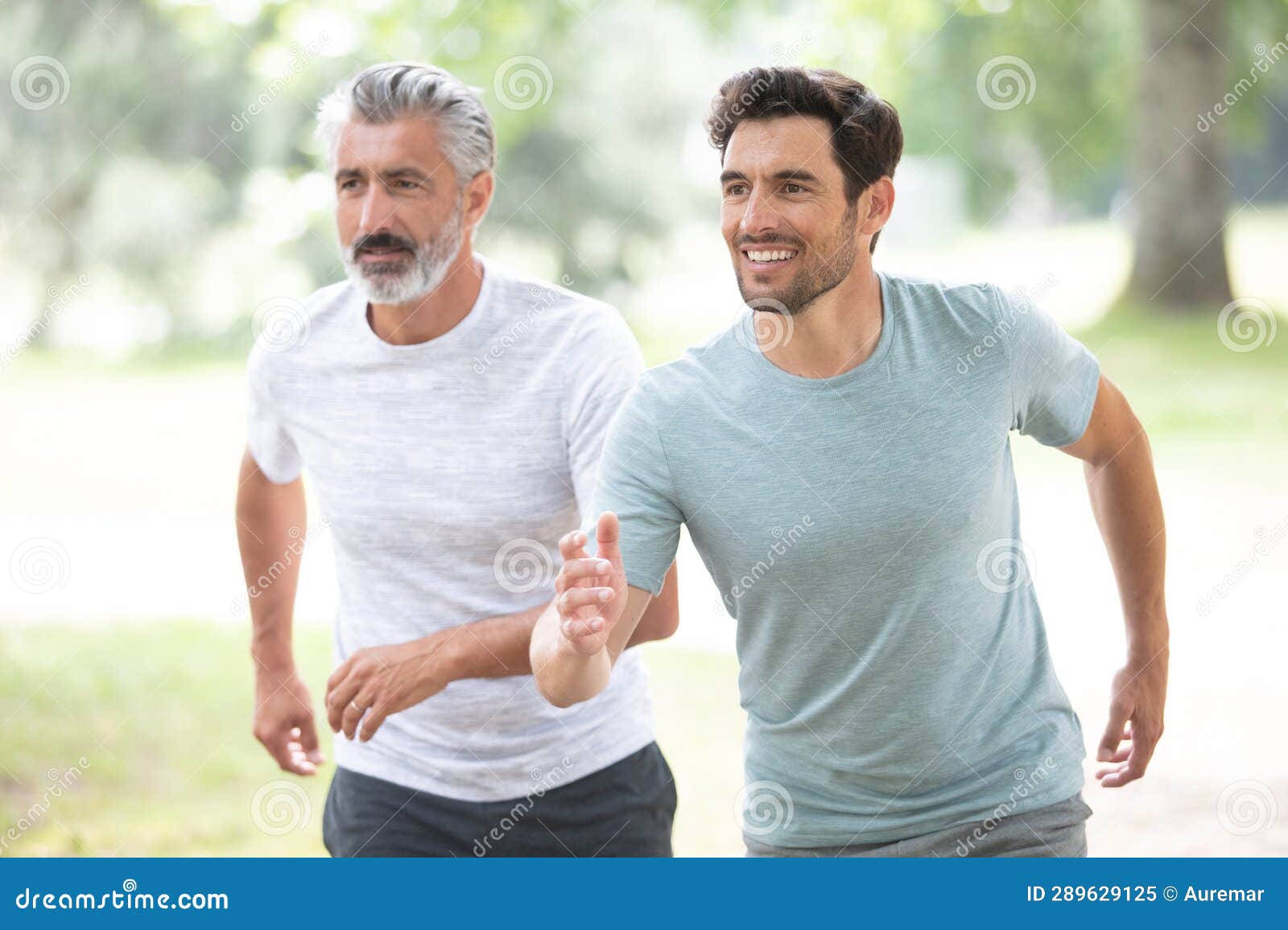 Two men running outdoors stock image. Image of games - 289629125