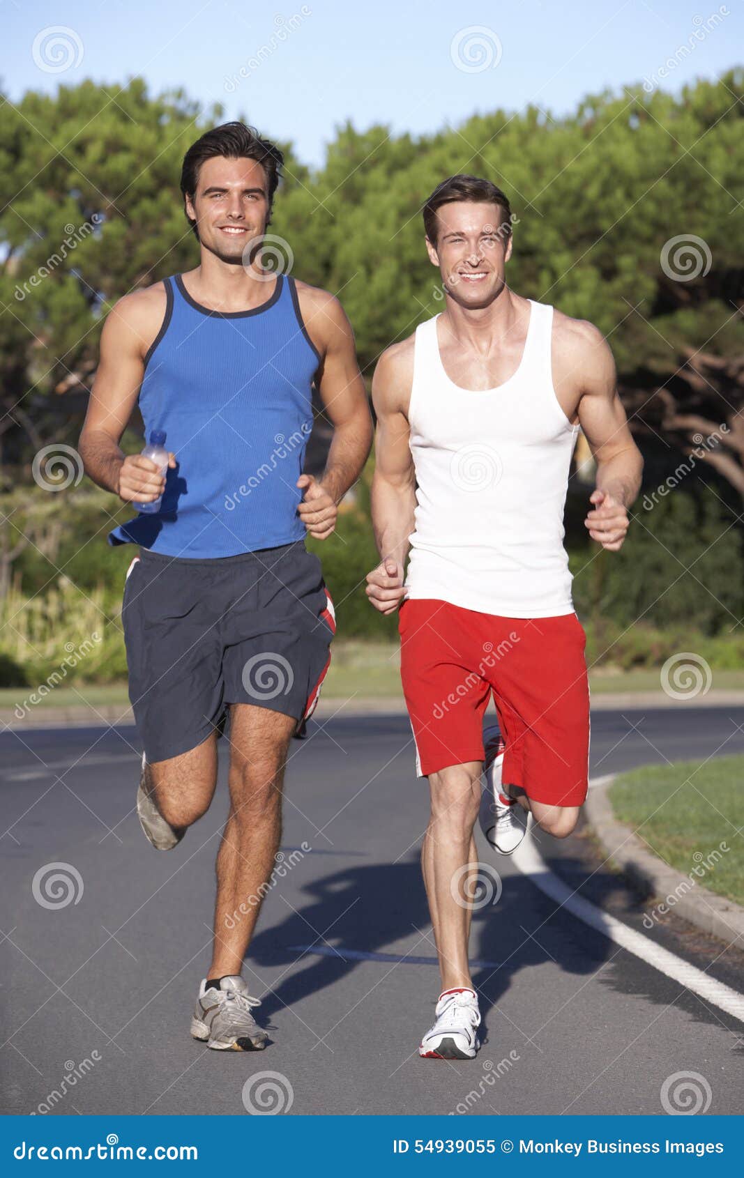 Two Men Running on Road stock image. Image of exercising - 54939055