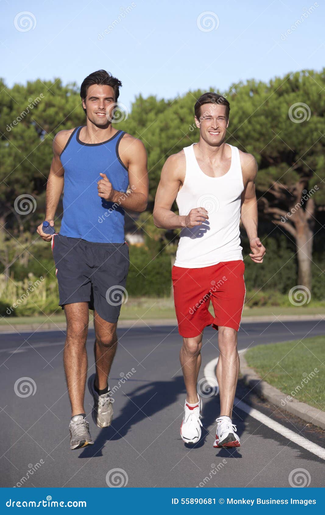Two Men Running on Road stock image. Image of together - 55890681