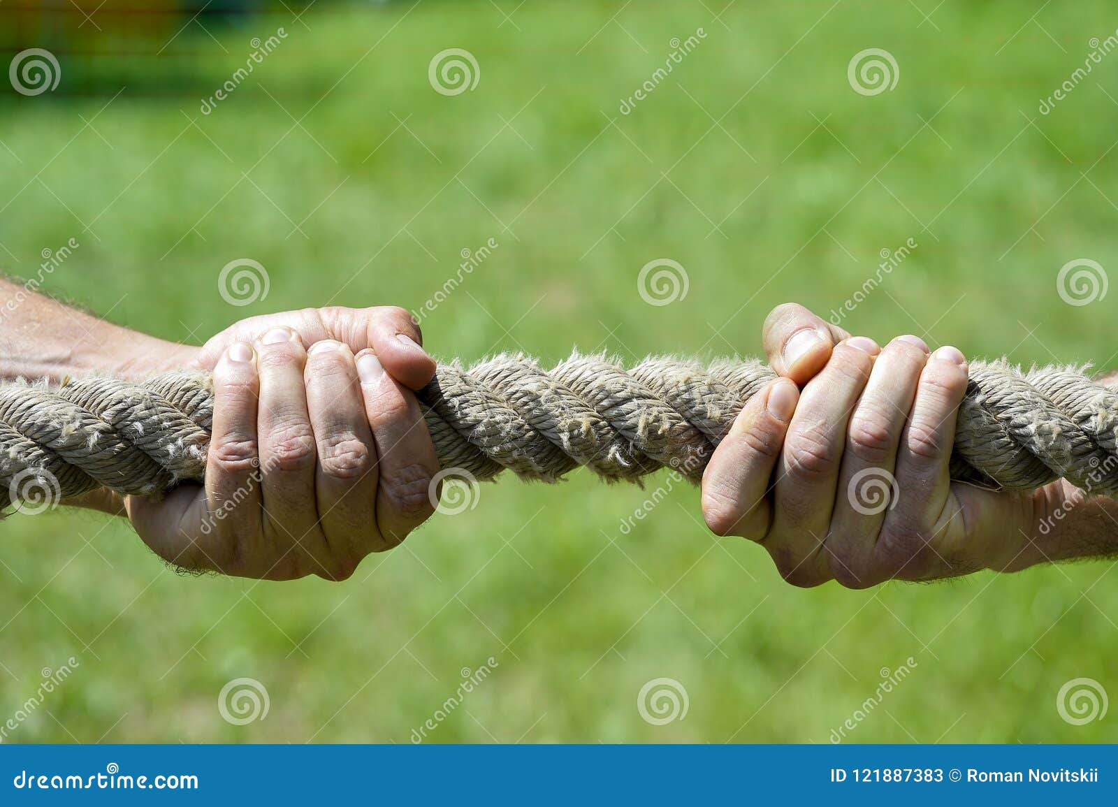 Two Men`s Hands Pull the Rope Each in His Own Direction. the Con Stock ...