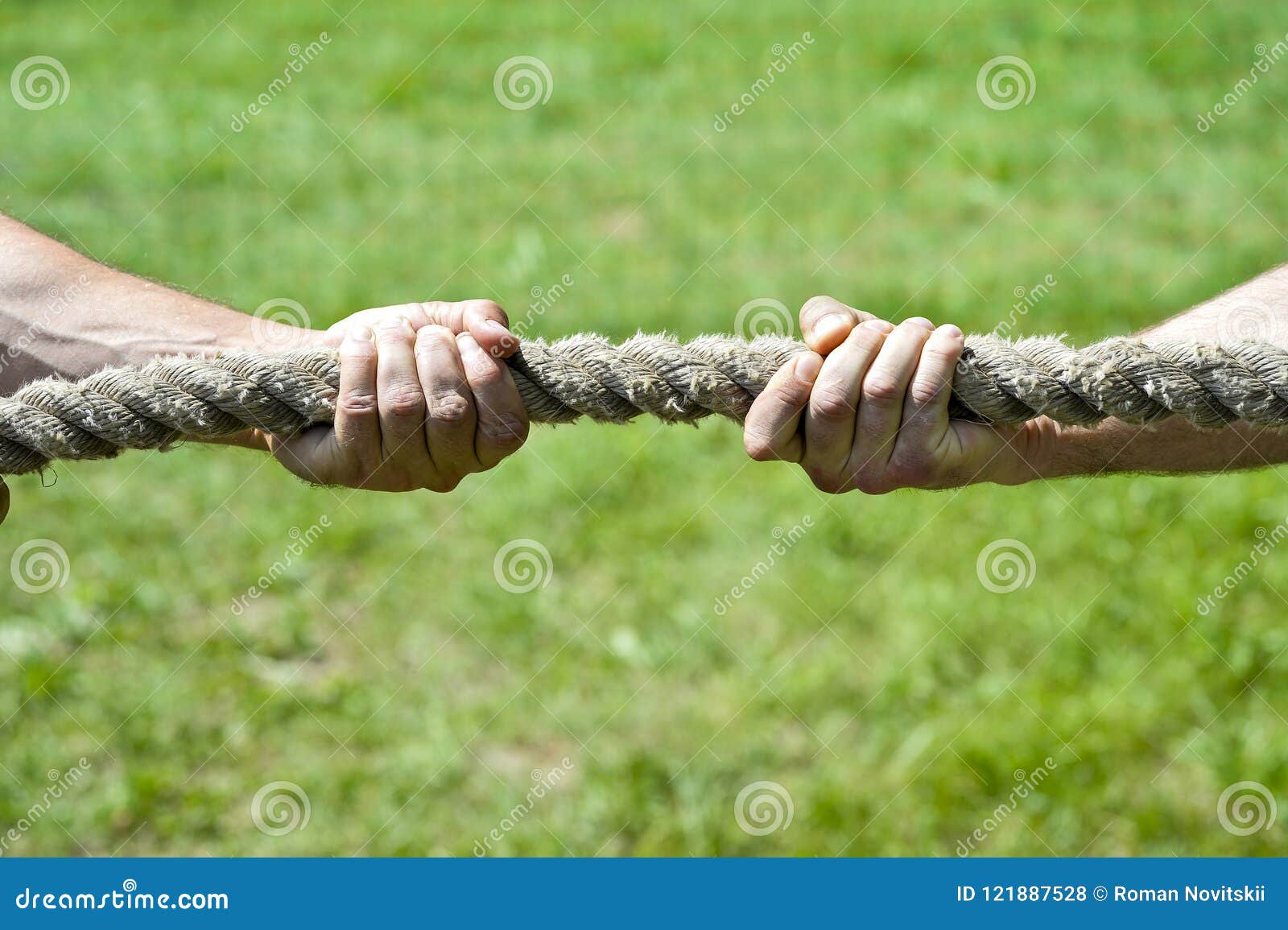 Two Men`s Hands Pull the Rope Each in His Own Direction. the Con Stock ...